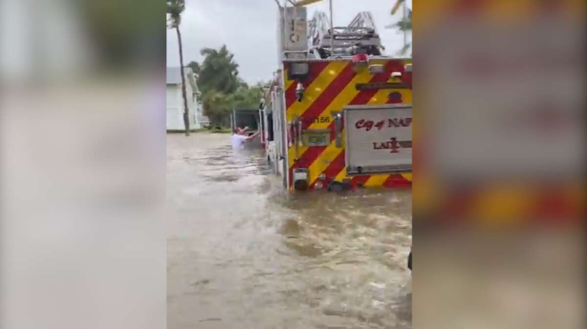 WATCH: Fire trucks submerged in floodwater in Naples
