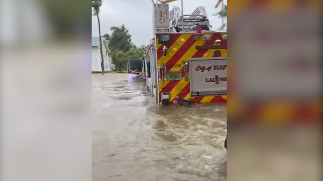WATCH: Fire trucks submerged in floodwater in Naples