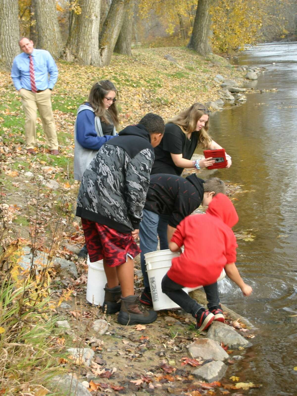 Big Rapids students help restock fish in Muskegon River