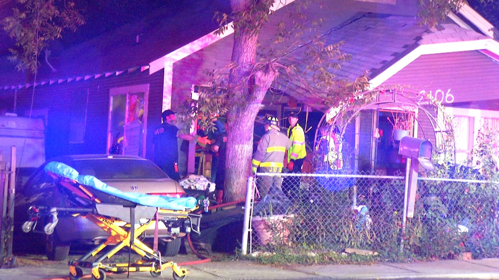 Woman, 80, was pinned under a car that crashes into home