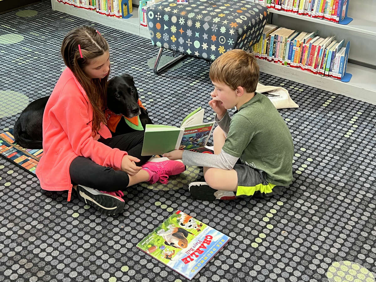 Youngsters enjoy 'Read to a Dog' days at library