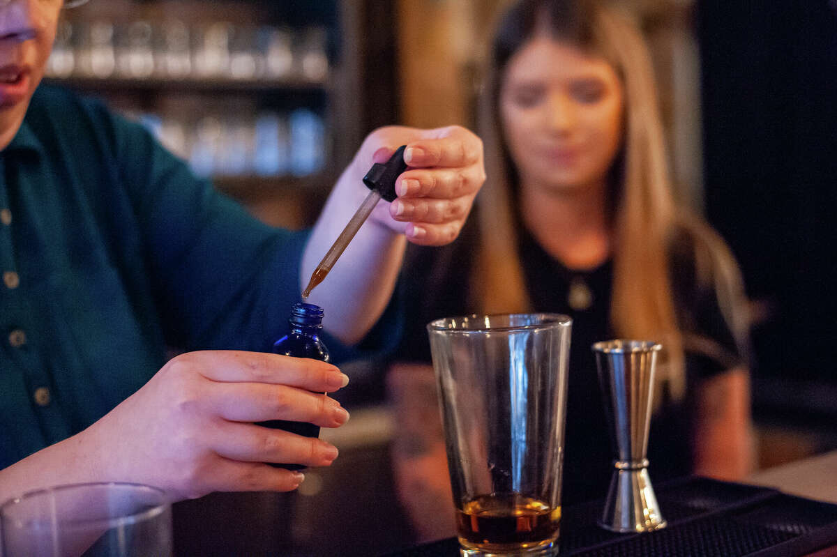 TORI TRIES...shaking things up as a bartender at Three Bridges Distillery