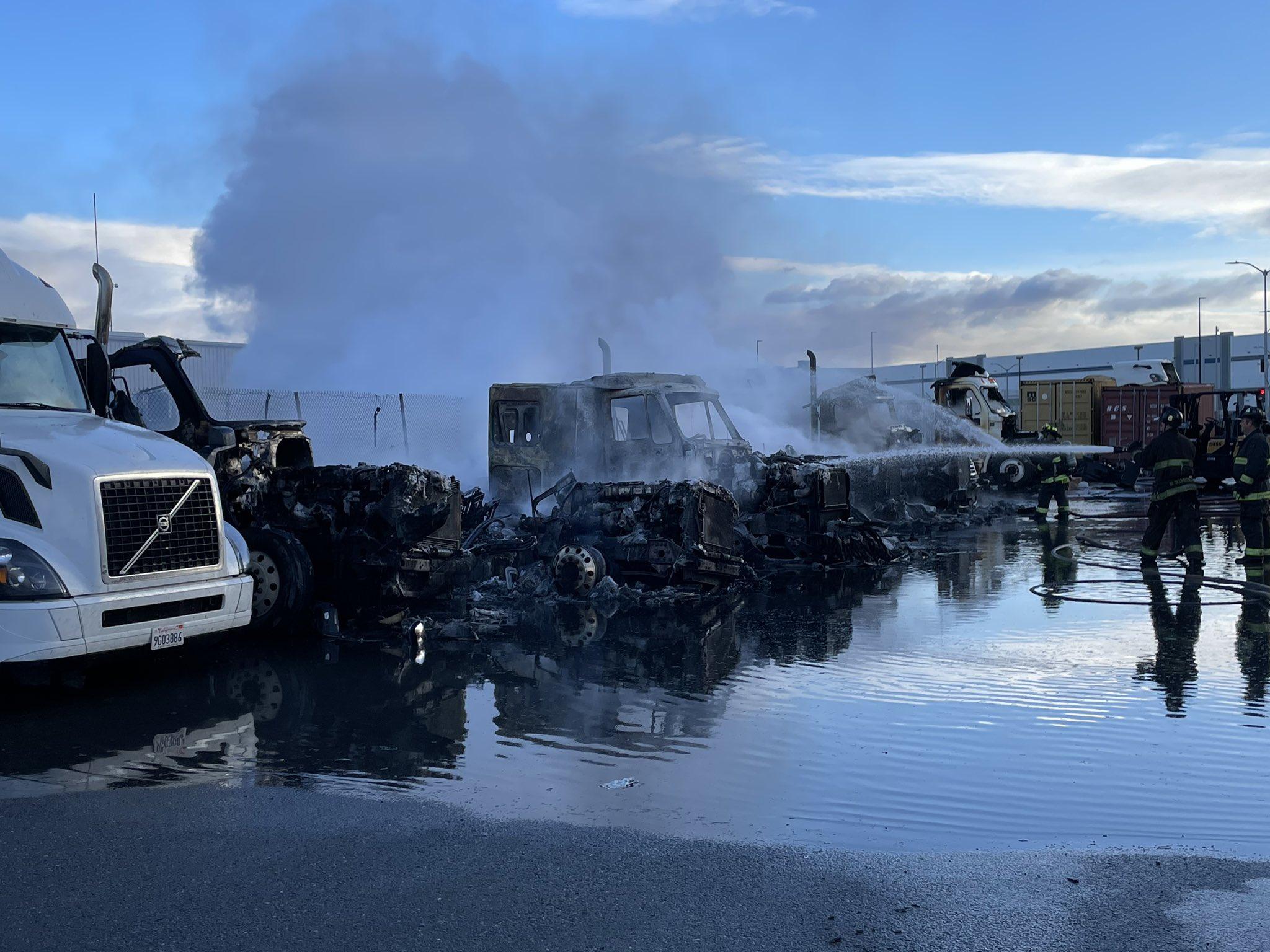 Oakland firefighters contain blaze that caught eight big rig trucks on fire