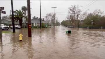 California storm: Kayakers paddle along flooded streets of Santa Barbara