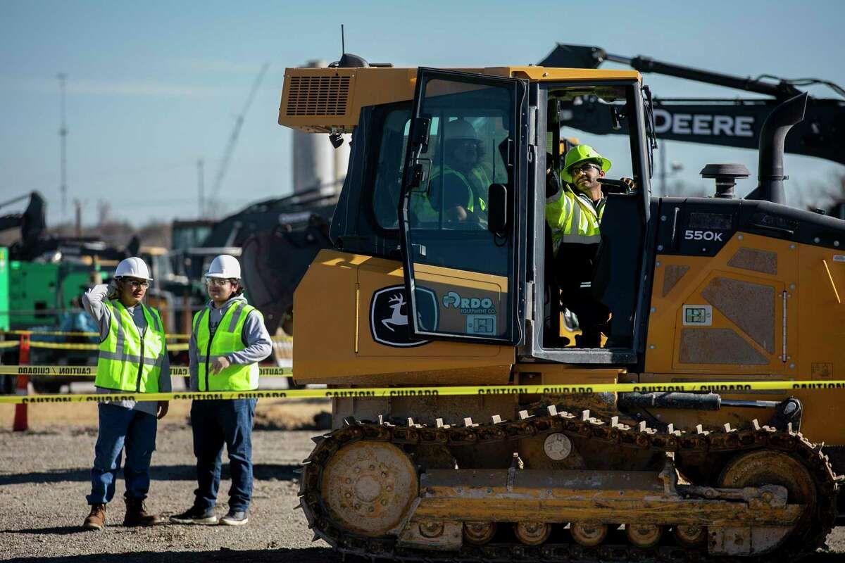 High school students get hands-on experience with heavy equipment