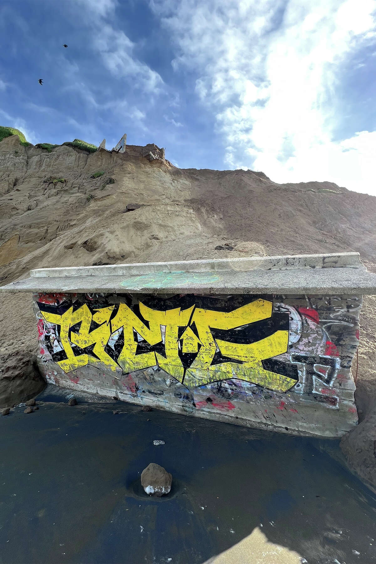 Photos shows WWII bunker on cliff's edge before it fell on SF beach