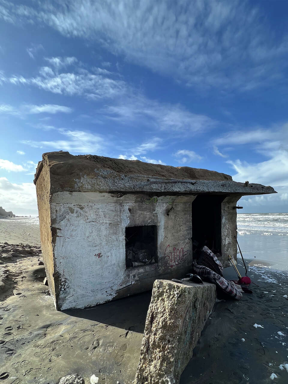 Photos shows WWII bunker on cliff's edge before it fell on SF beach