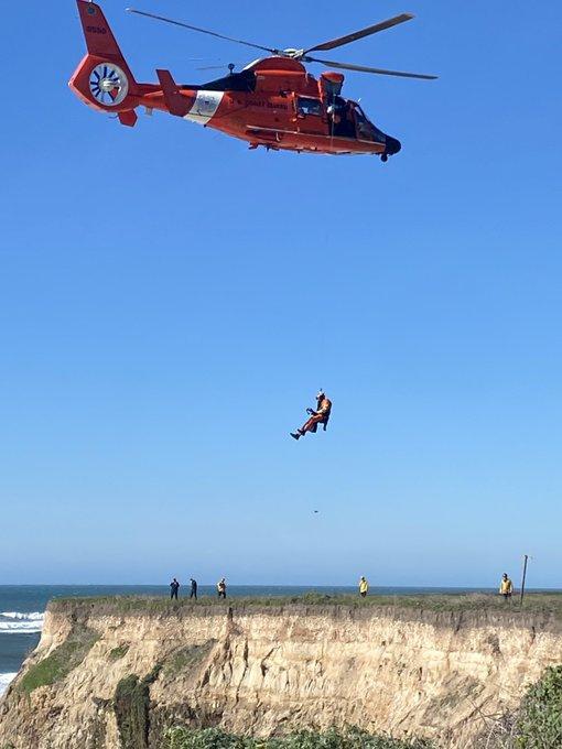 Rescuers use chopper to pluck surfer to safety amid high tide