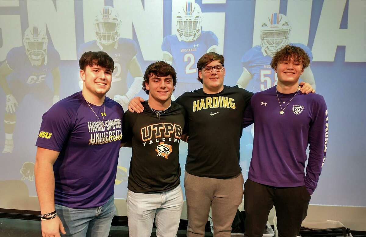 Four MCS football players celebrate their college signings