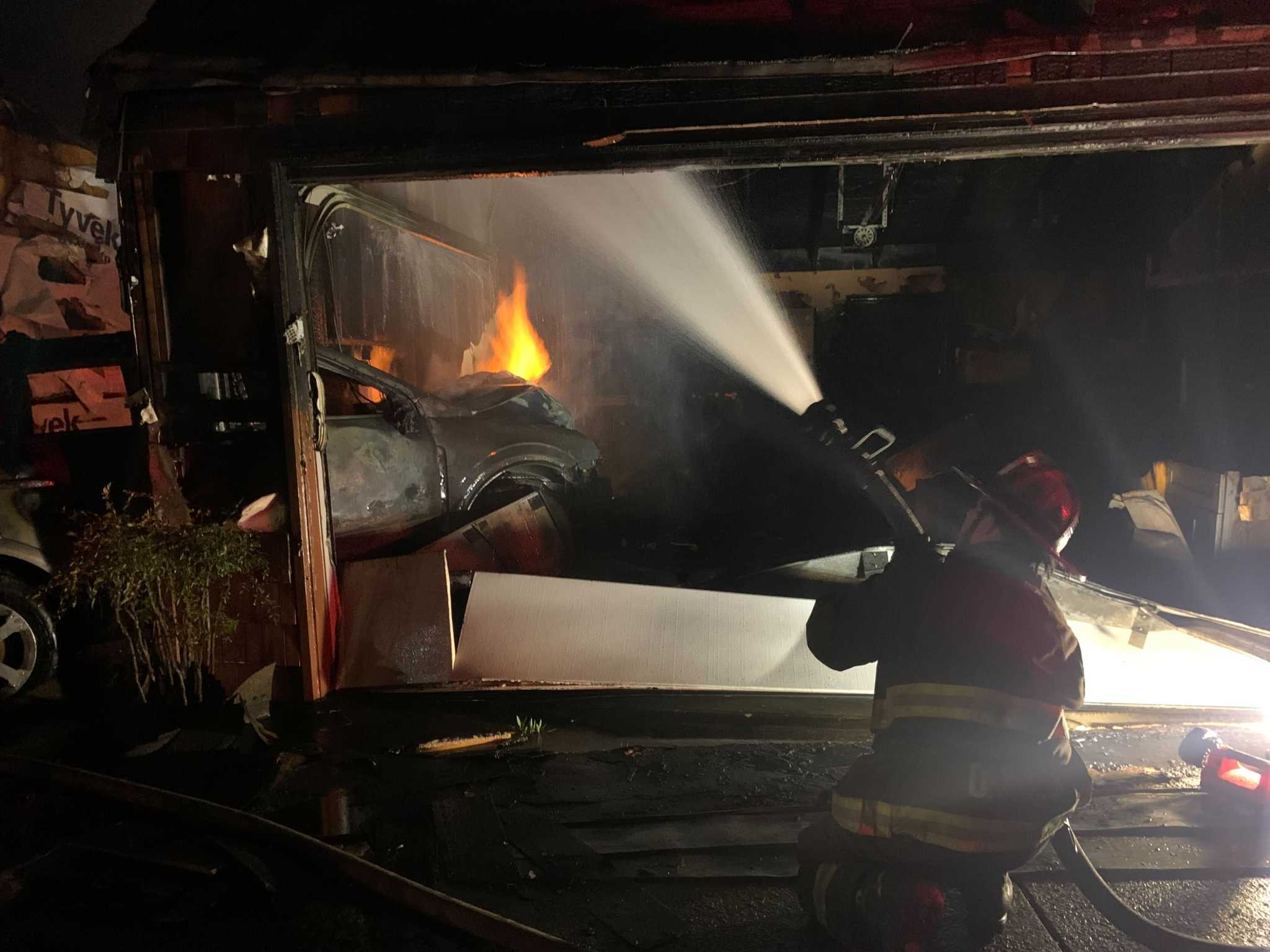 Car slams into Oakland garage, igniting gas-fed fire