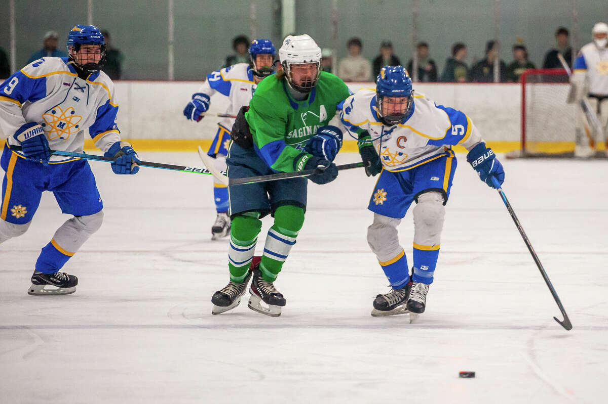 PHOTOS: Midland and Saginaw Heritage high schools clash in hockey regi