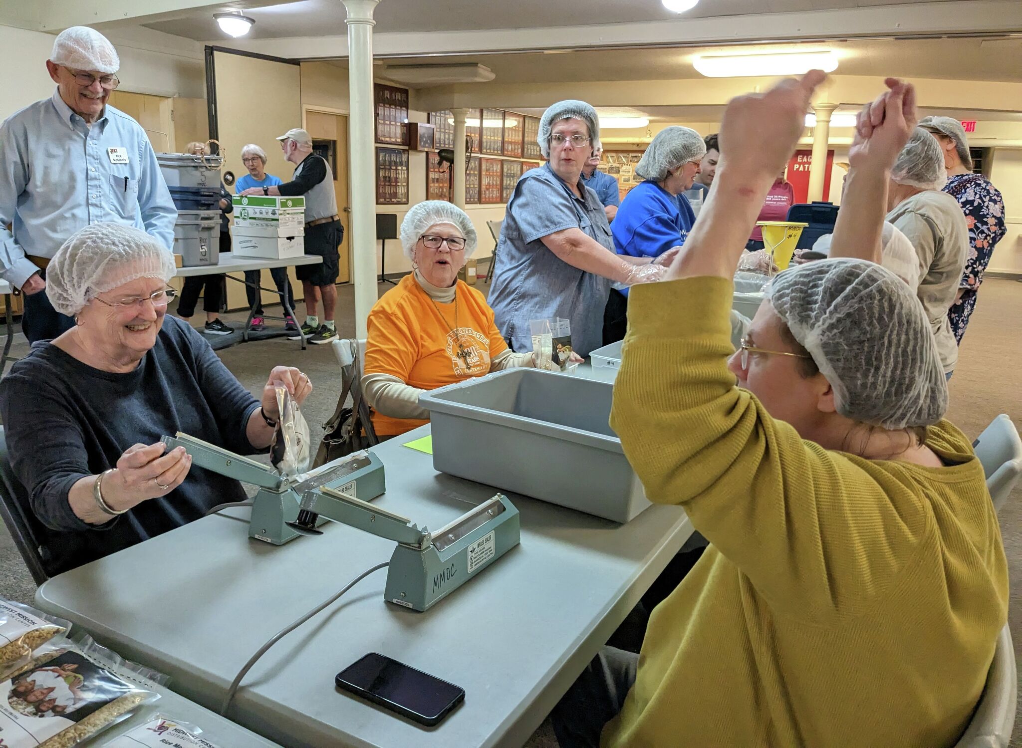 Holy Spokes Cluster volunteers pack meals for Midwest Mission