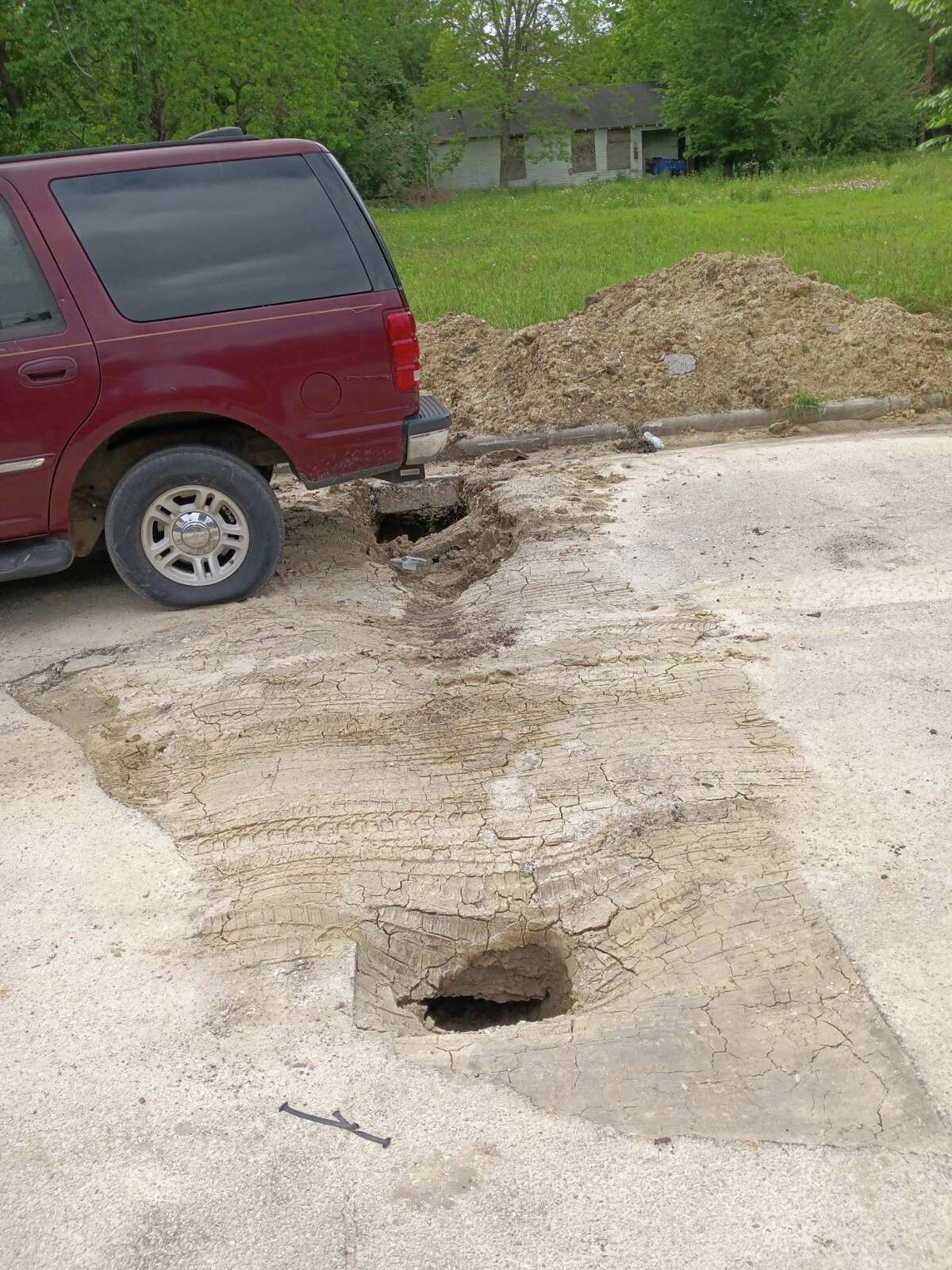 Houston man stands in street hole to get the city's attention