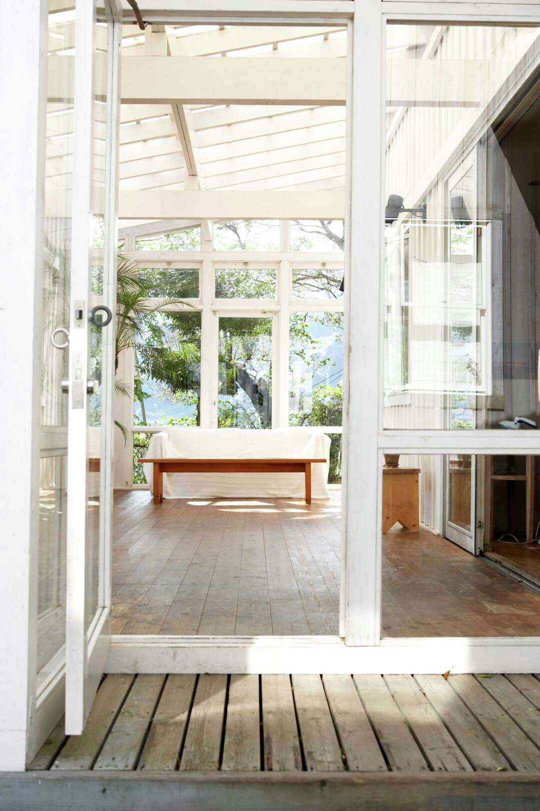 How to Convert a Covered Deck Into an Indoor Living Area