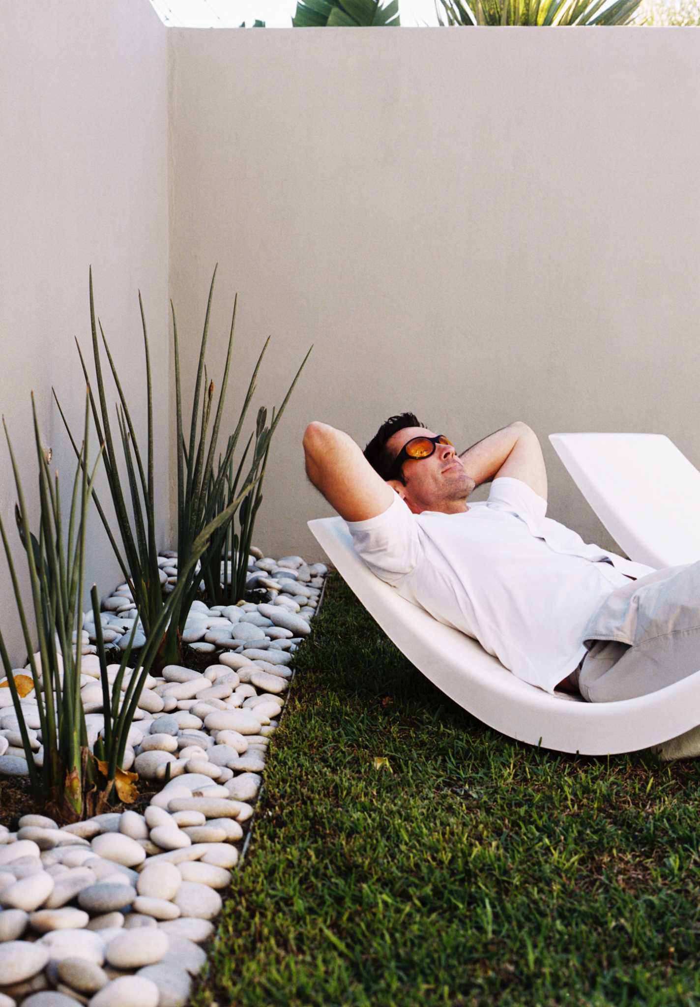 Rock Landscaping Design Ideas With a Stone Divider Between the Rock & Grass