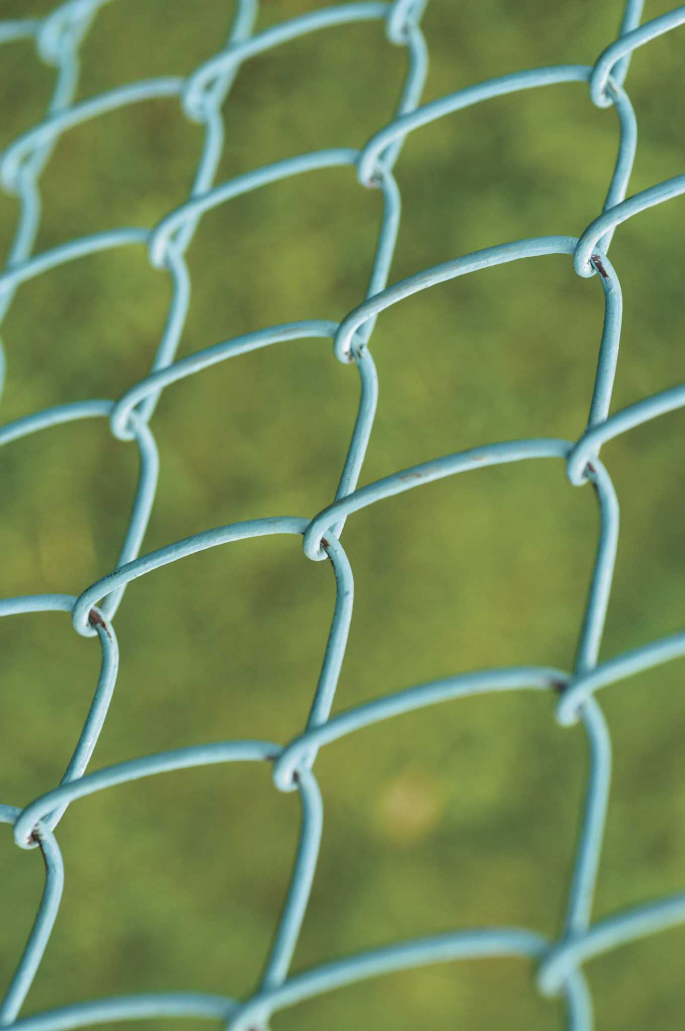 How to Prevent Grass From Growing Under a Chain Link Fence