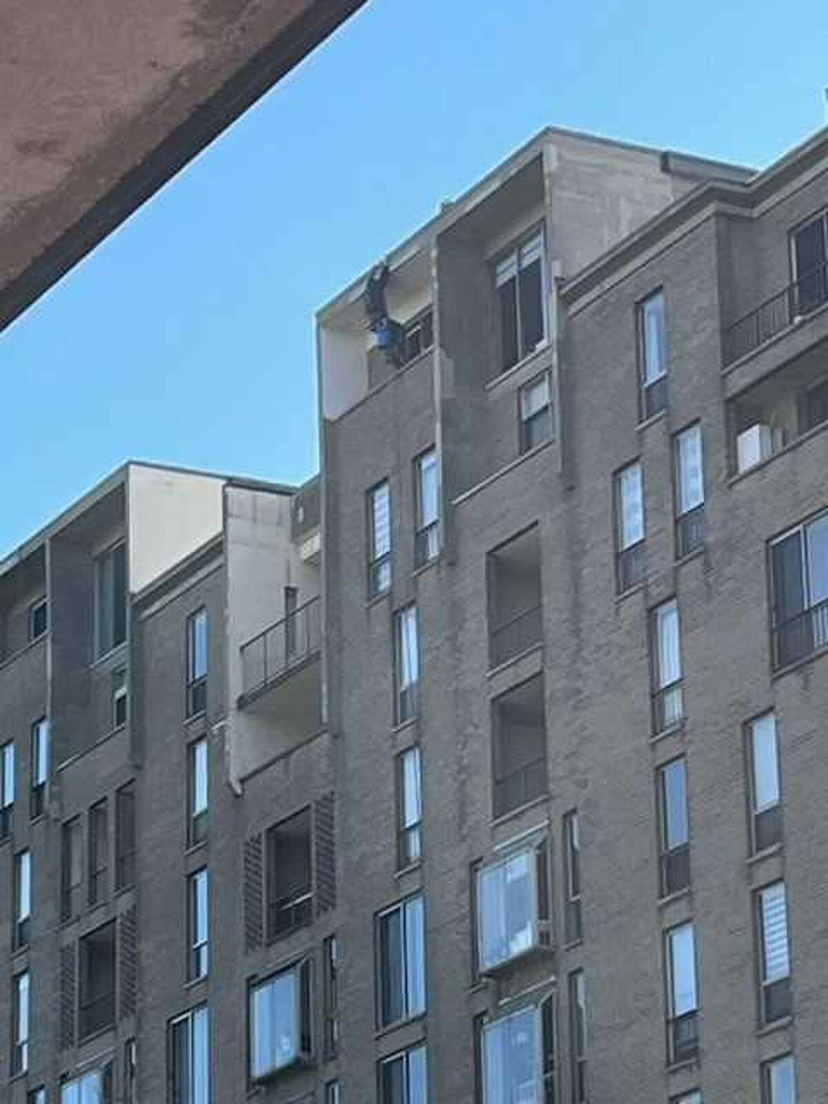 Dangling window washer rescued from 12 stories up