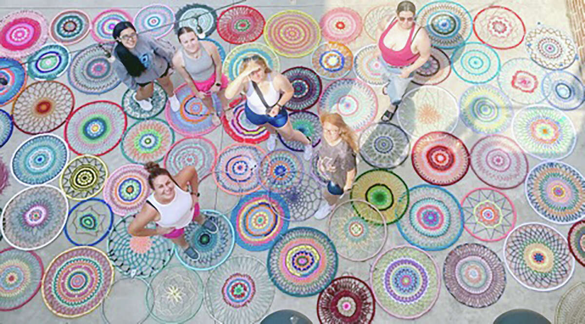 Circling back: Jerseyville students refresh hula hoop yarn art canopy