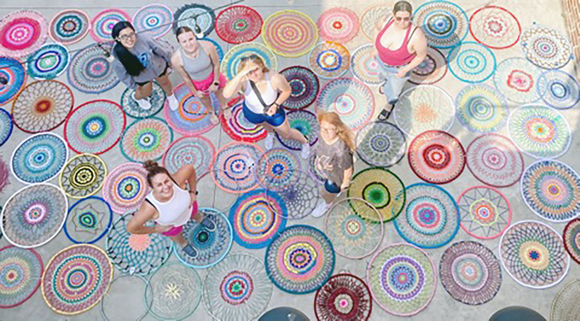 Circling back: Jerseyville students refresh hula hoop yarn art canopy