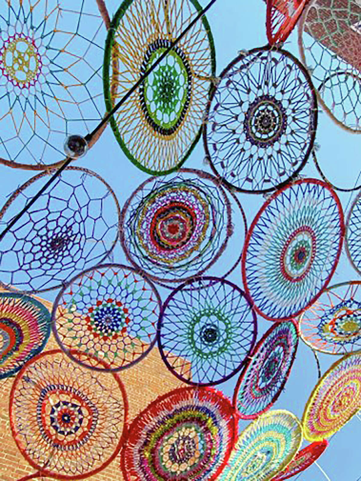 Circling back: Jerseyville students refresh hula hoop yarn art canopy