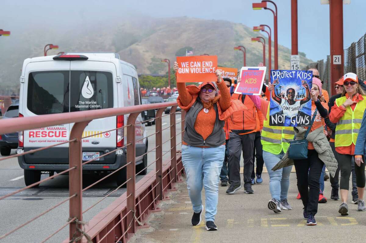 Here’s why hundreds in orange marched across Golden Gate Bridge