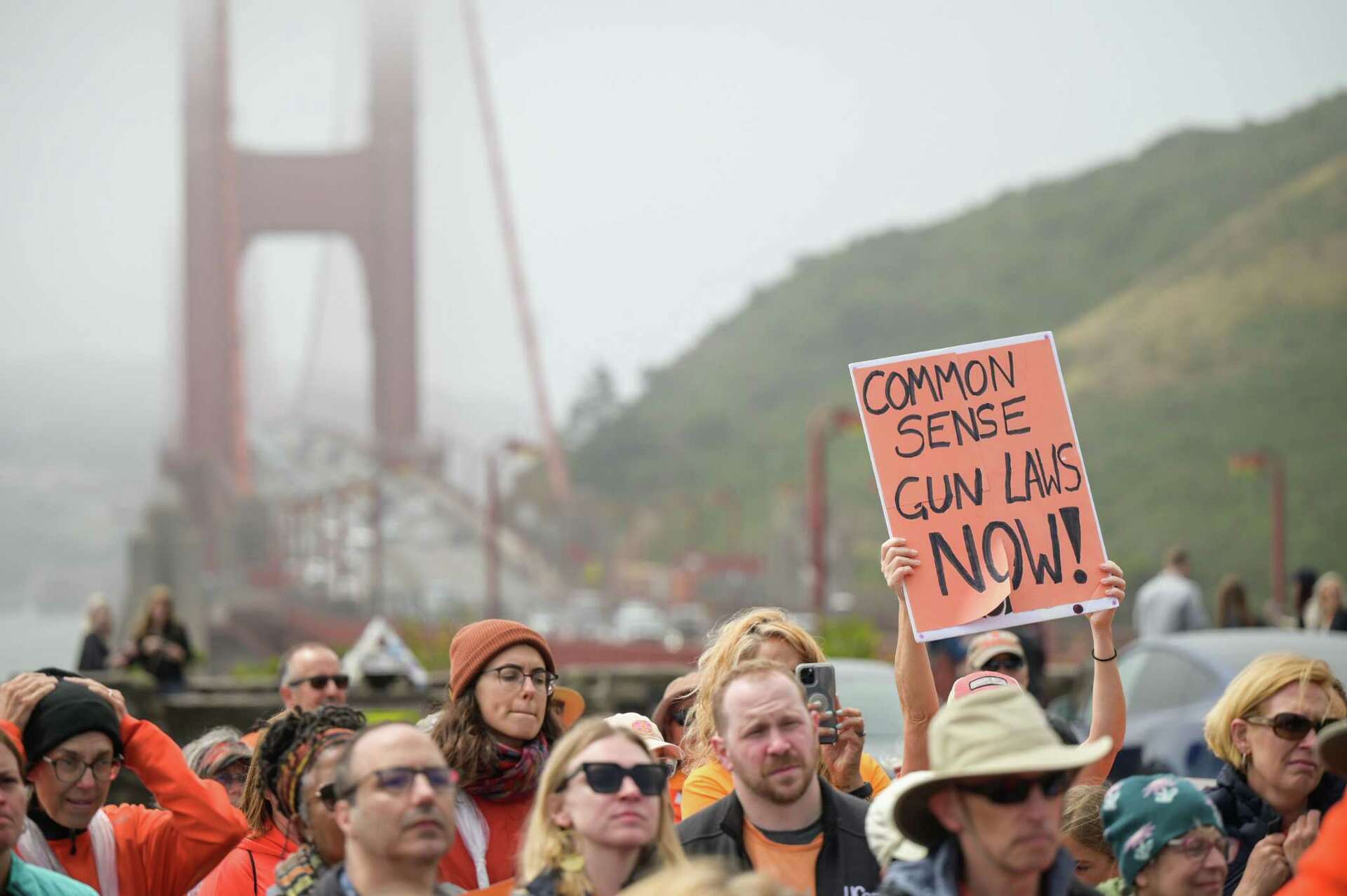 Here’s why hundreds in orange marched across Golden Gate Bridge