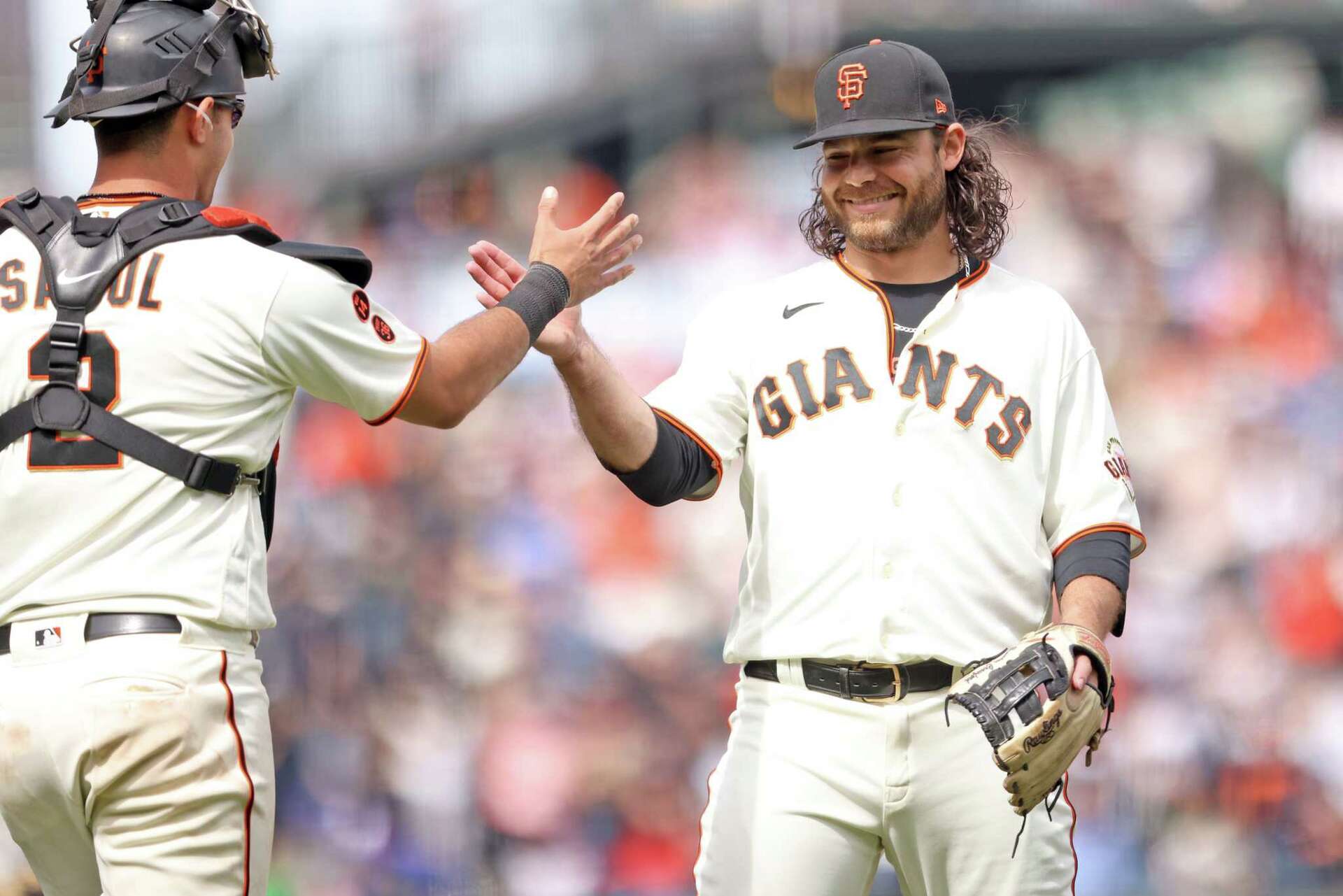 Giants' Brandon Crawford celebrates his 0.00 ERA after pitching debut