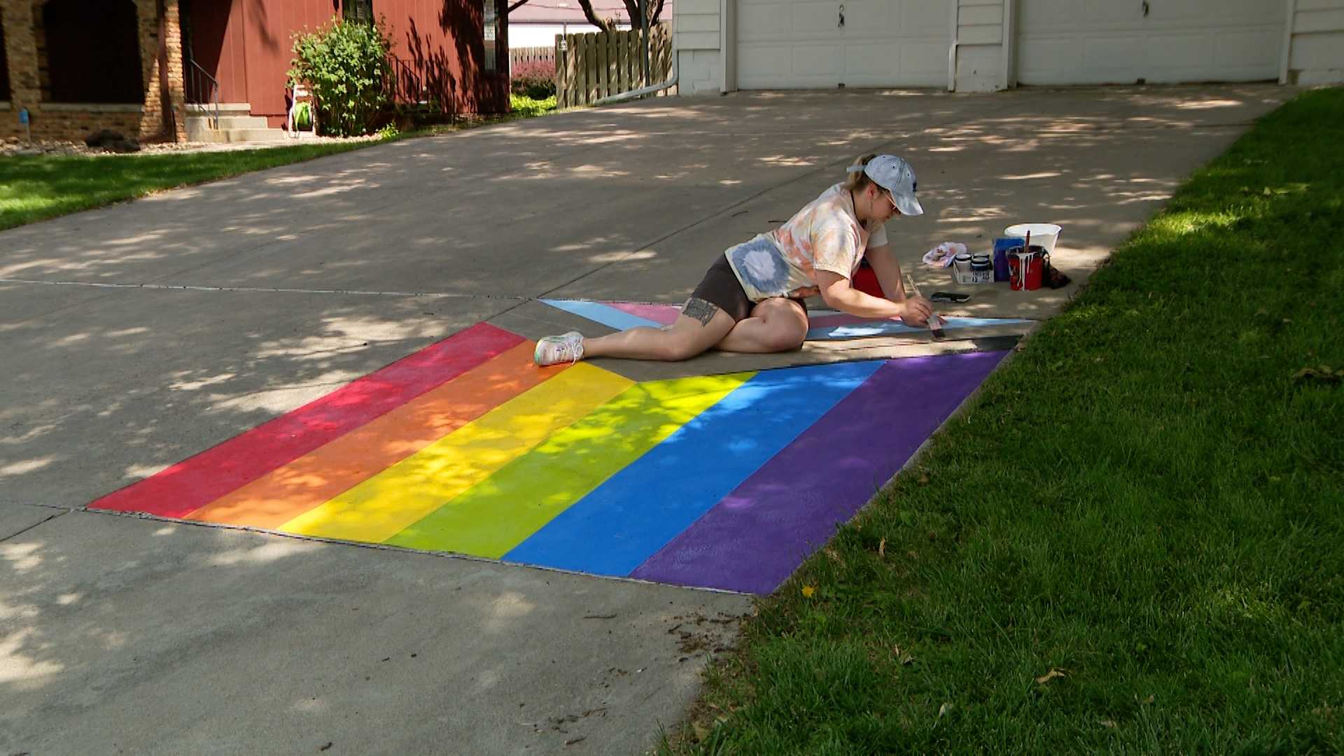 More than a painting: Artist paints Pride flag in driveway to replace ...