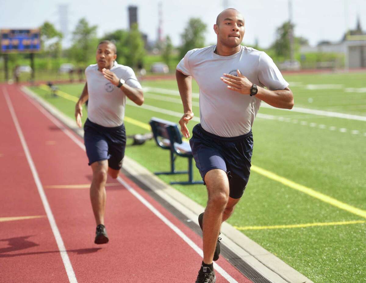 Bridgeport police recruits run an open workout at Harding High