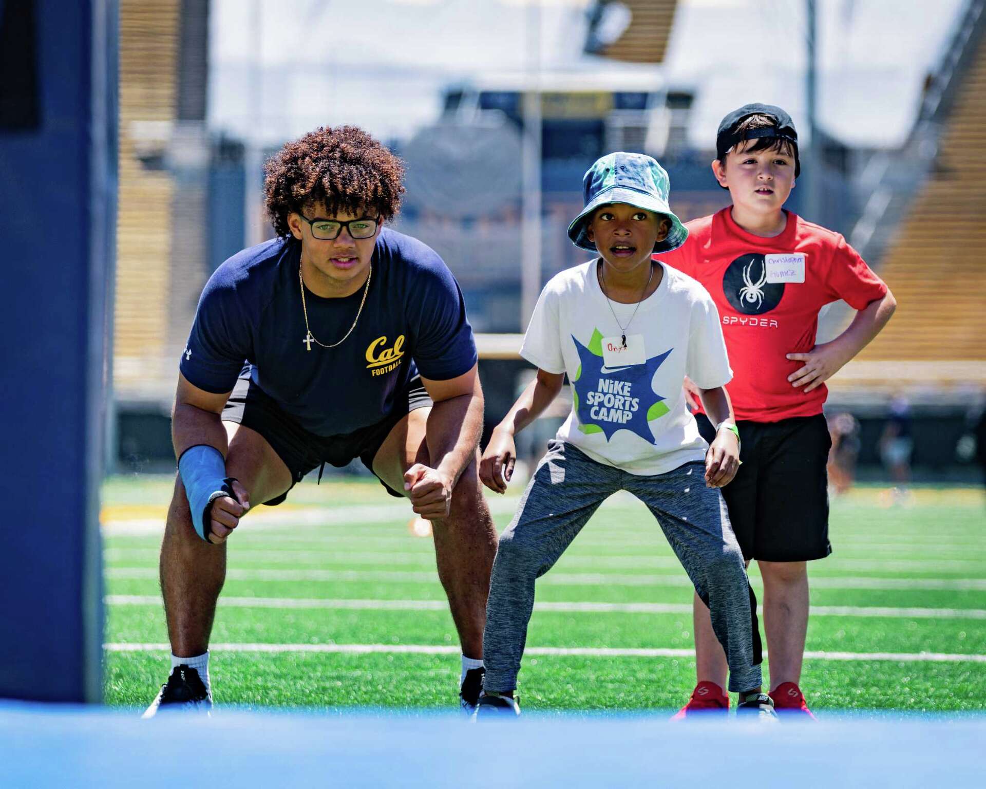 Cal players open doors to football for kids often left on the sideline