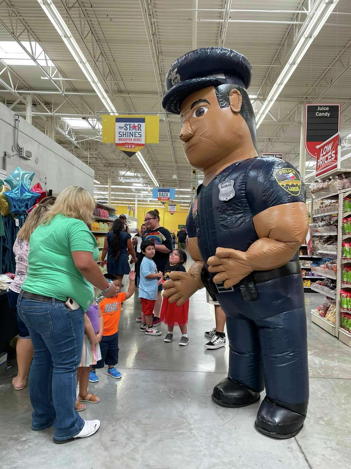 Children meet law enforcement mascots at H-E-B Kid's Day!