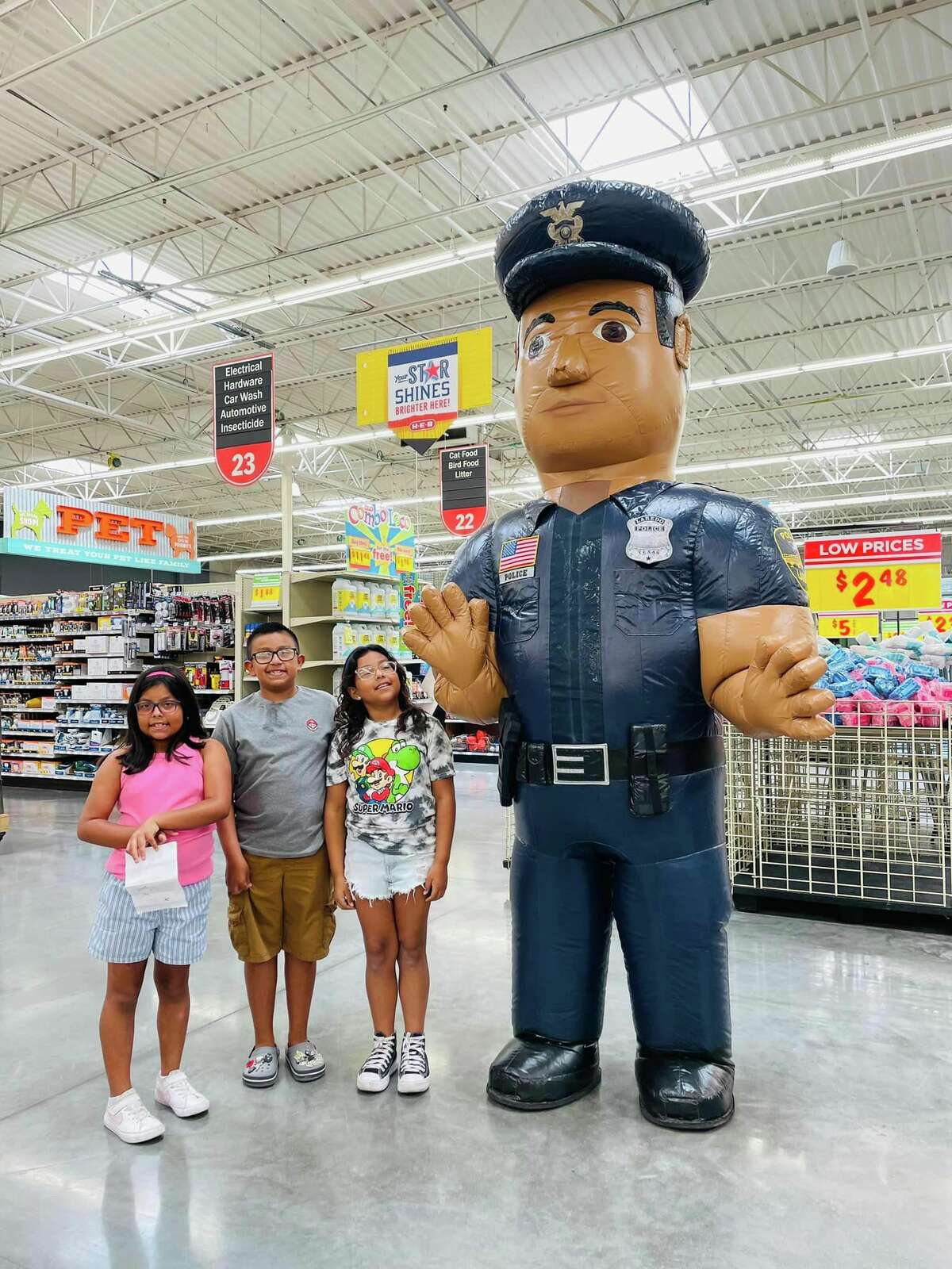 Children meet law enforcement mascots at H-E-B Kid's Day!