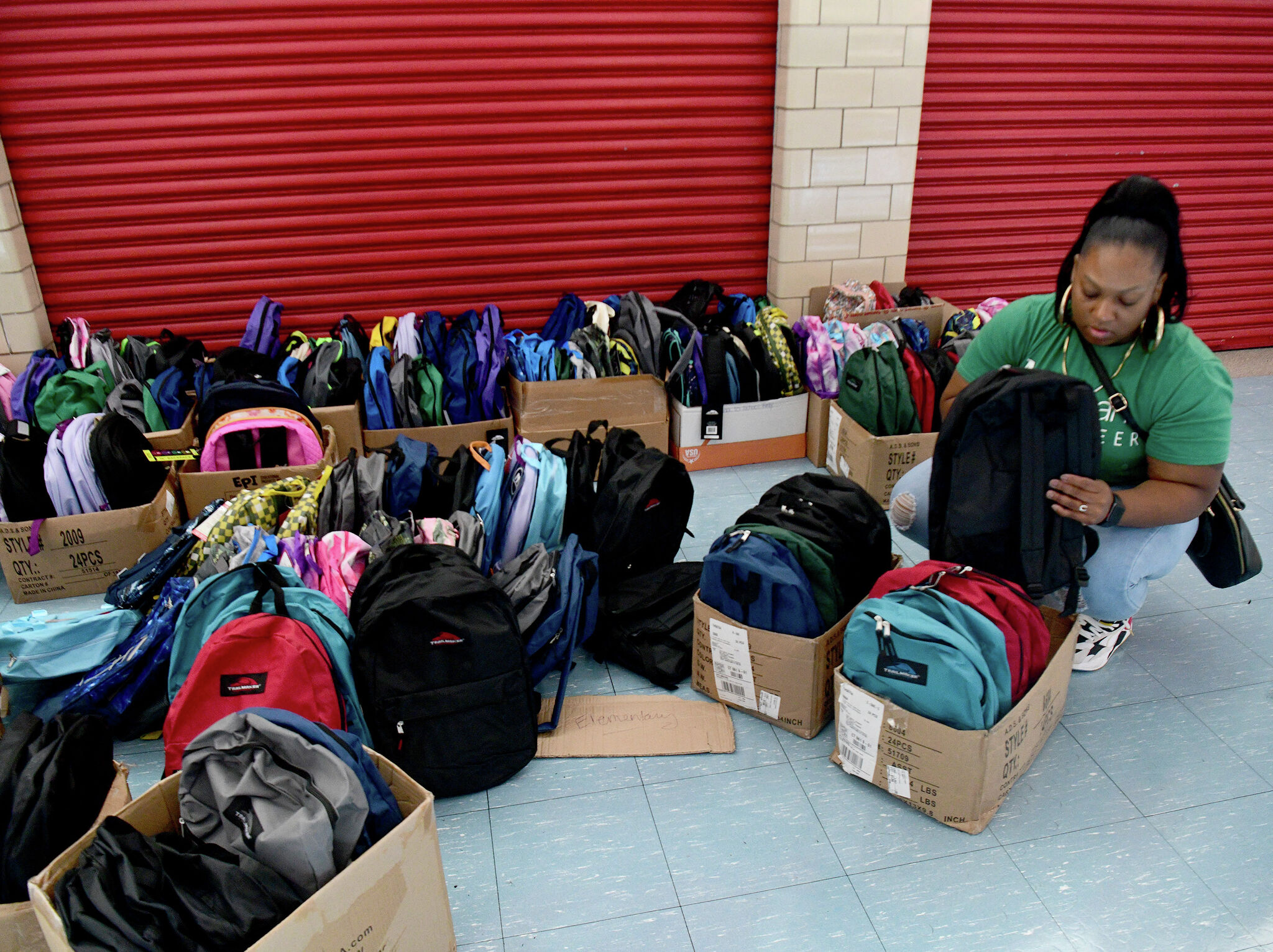 Volunteers in East Hartford assemble backpacks for students in need