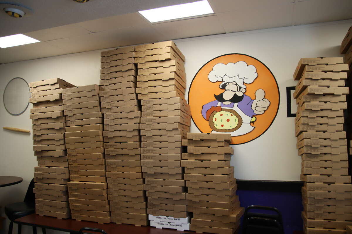 On the job: Max Milne puts together his first pizza with Pizza Dude