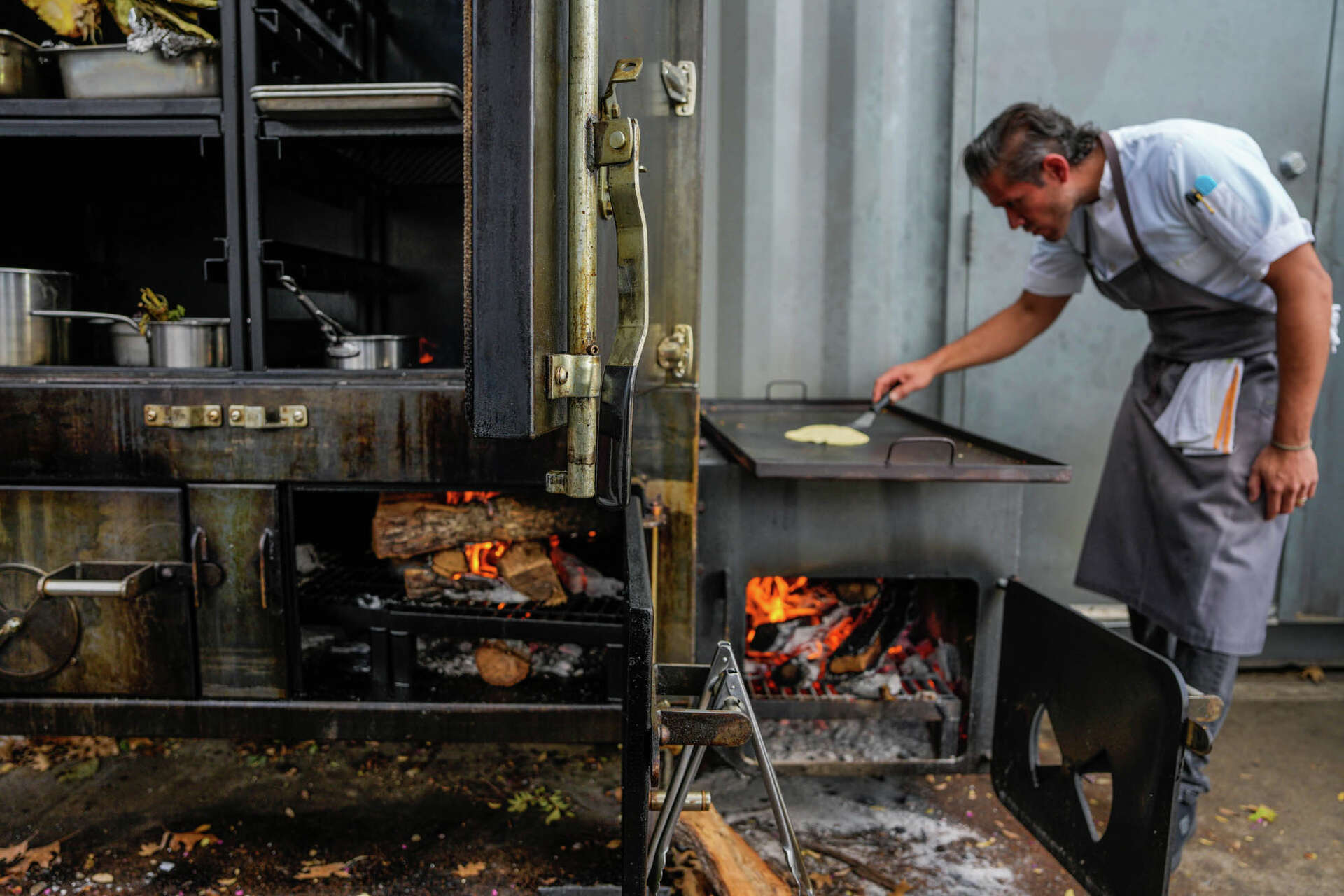 Fancy restaurants in Houston are using live fire barbecue techniques