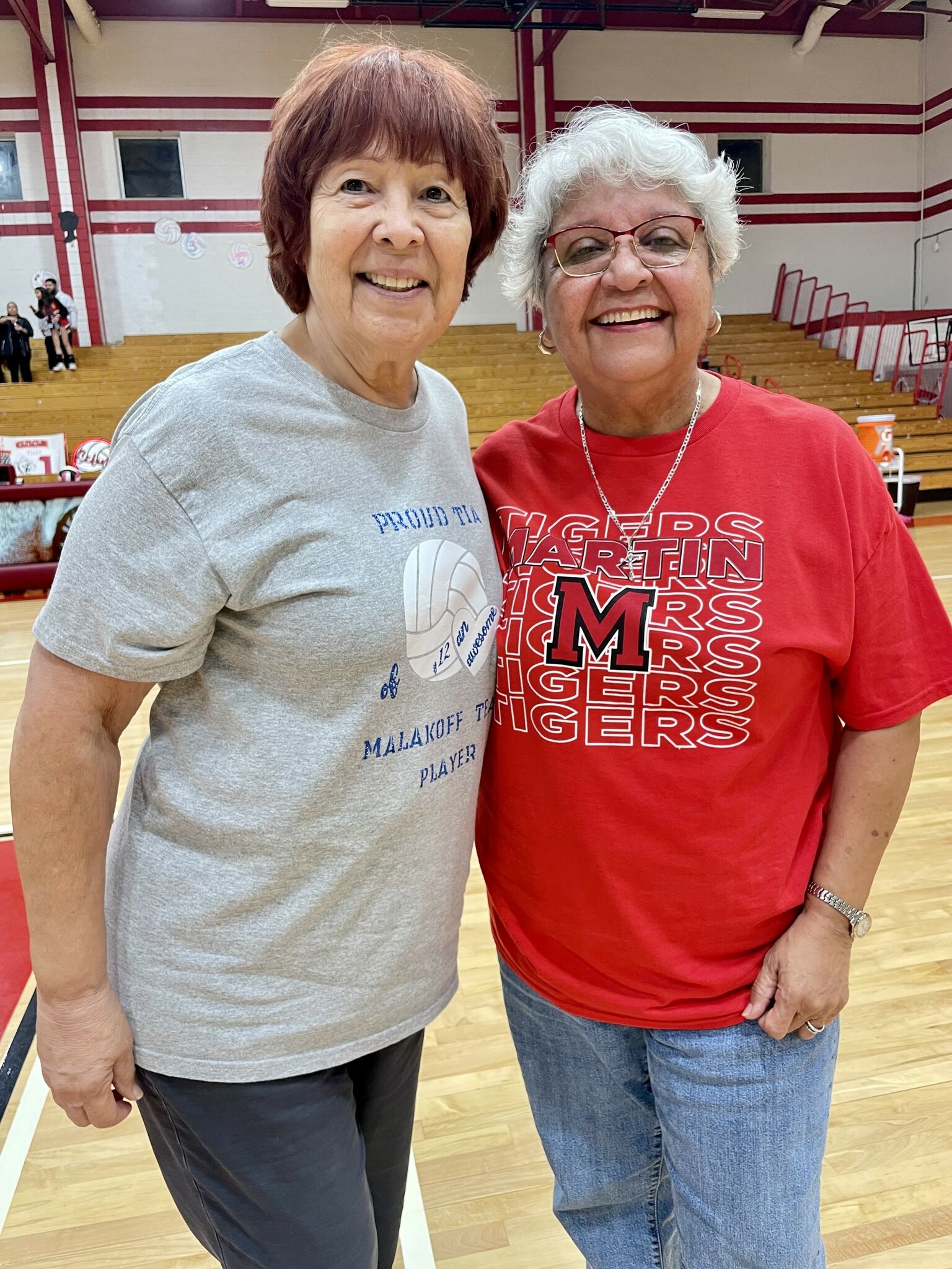 Retired Cigarroa and Martin coaches cheer teams on during rivalry game
