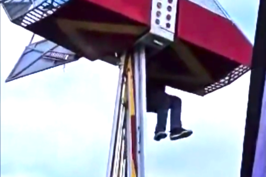 VIDEO: Festival worker dangles off ride, 30 feet in the air