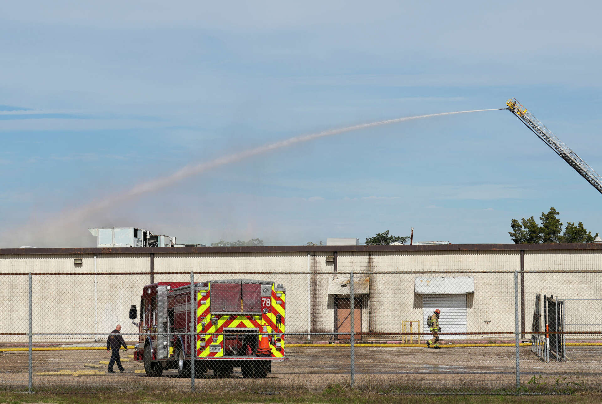 Houston fire: Crews working to put out warehouse fire, roof partially