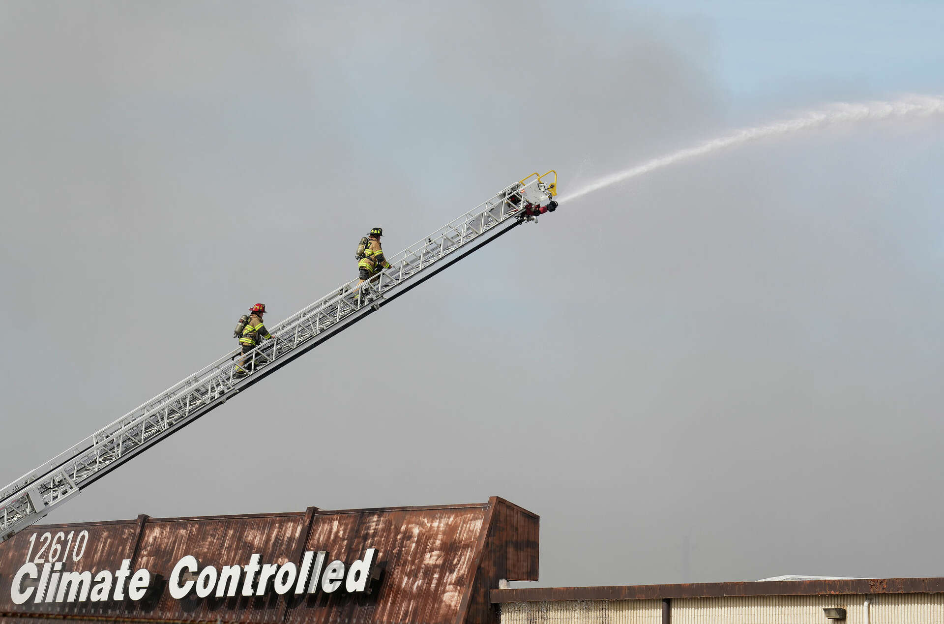 Houston fire: Crews working to put out warehouse fire, roof partially