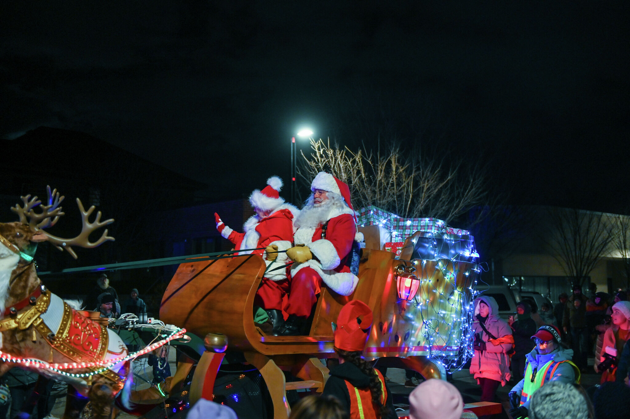 A crowd cheers Santa and Mrs. Claus Tuesday night in Midland