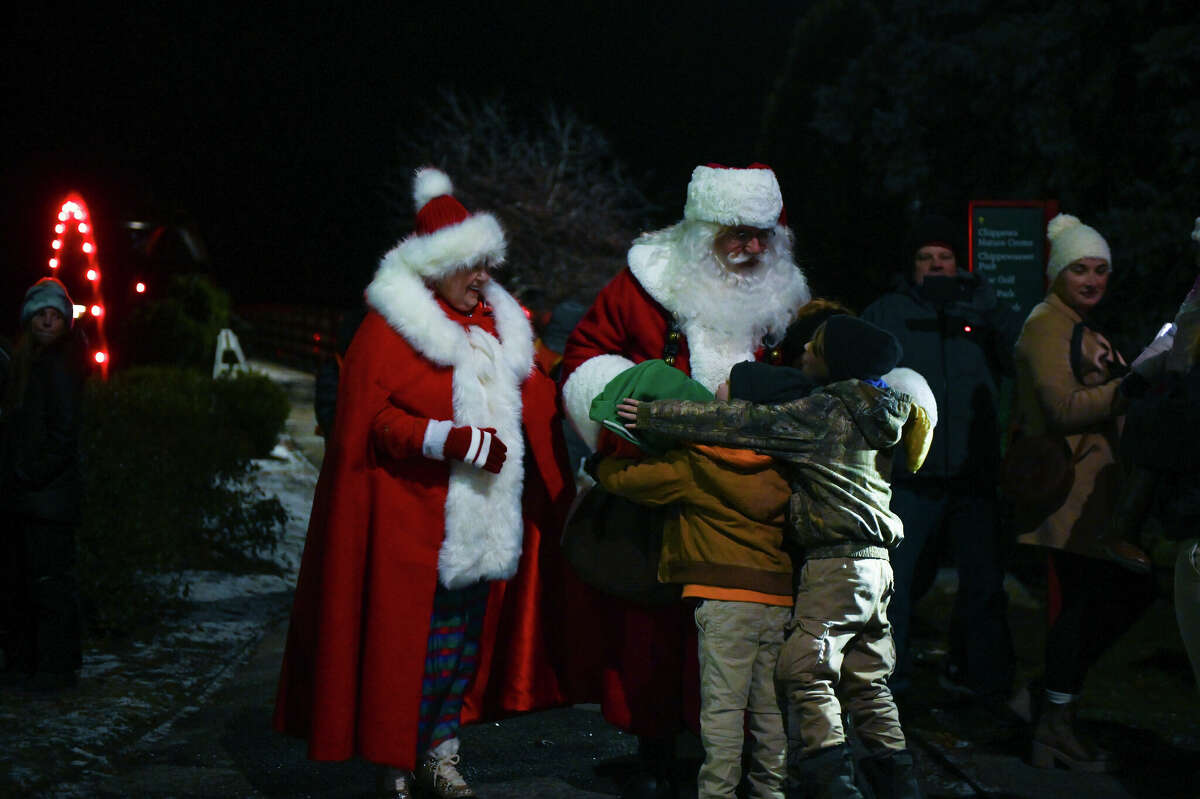 A crowd cheers Santa and Mrs. Claus Tuesday night in Midland