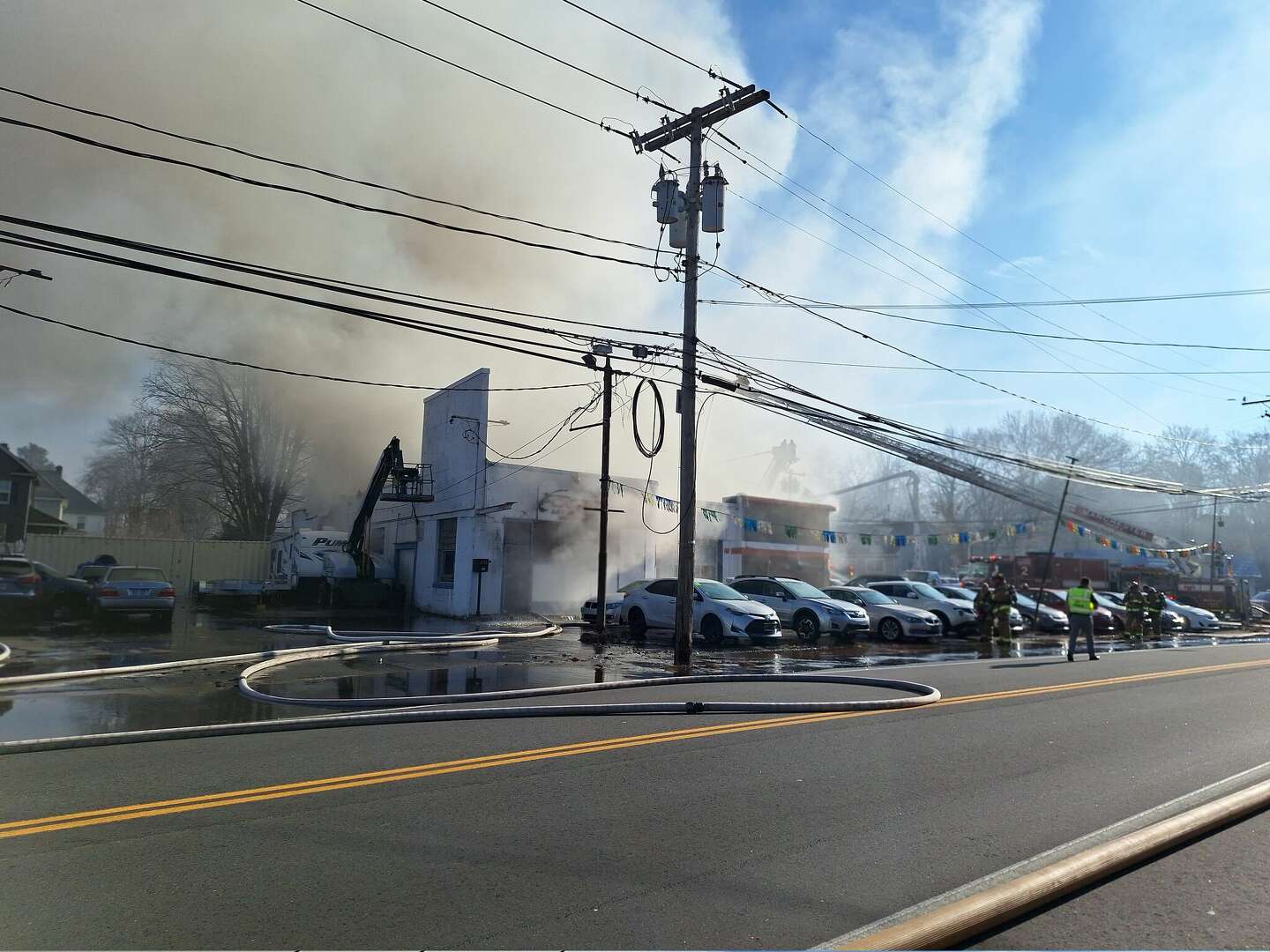 Fire at Manchester dealership fire damaged nearby home, officials say