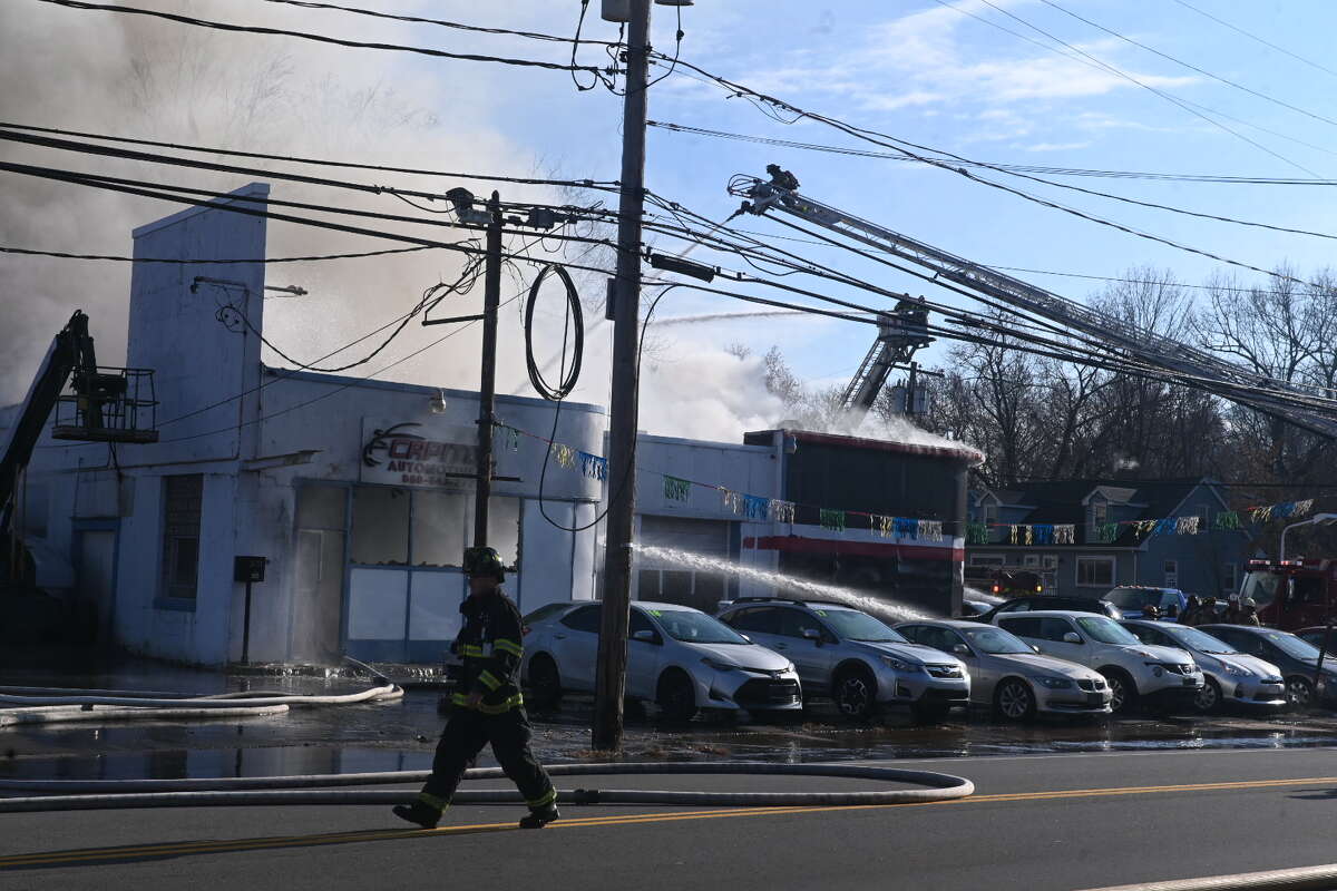 Fire at Manchester dealership fire damaged nearby home, officials say