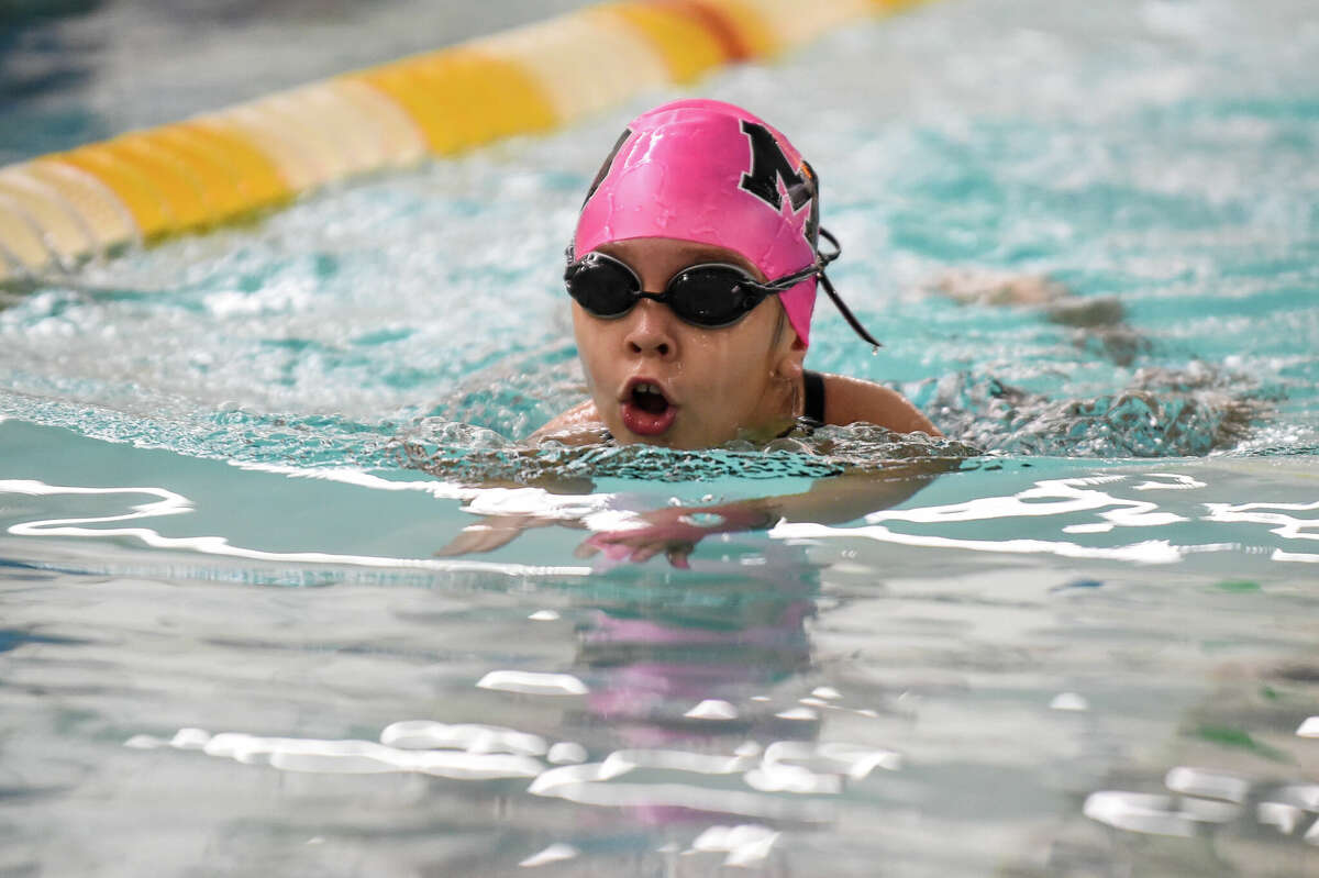 Midland Dolphins wear pink swim caps to support coach battling cancer
