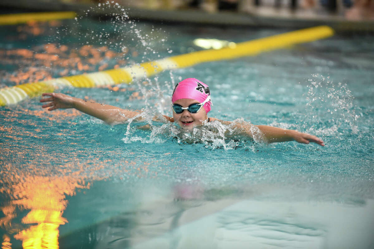 Midland Dolphins wear pink swim caps to support coach battling cancer