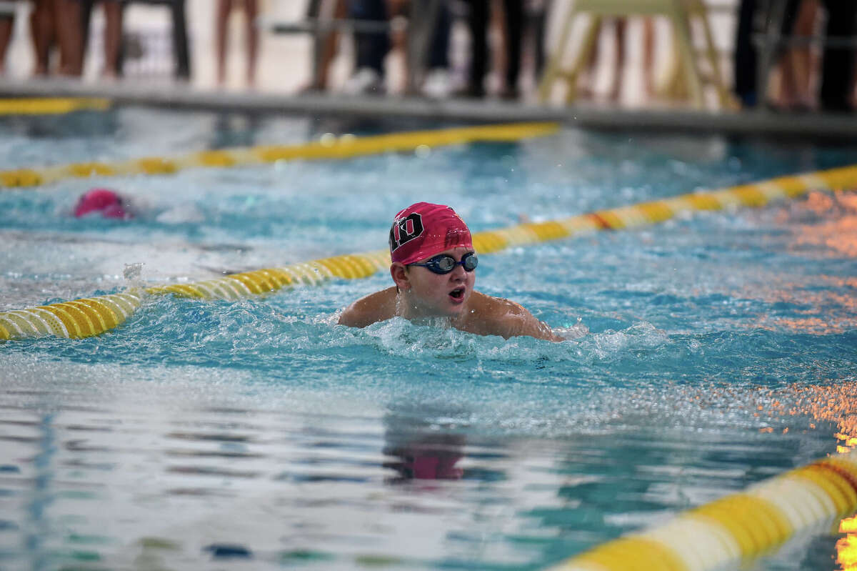 Midland Dolphins wear pink swim caps to support coach battling cancer