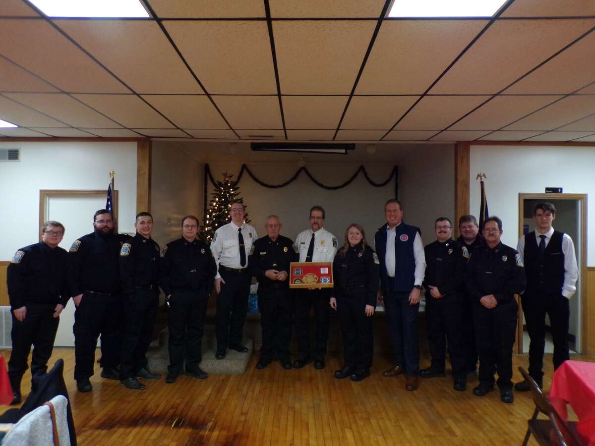 Michigan State Fire Marshal awards 50-year service coin to Marvin Bell