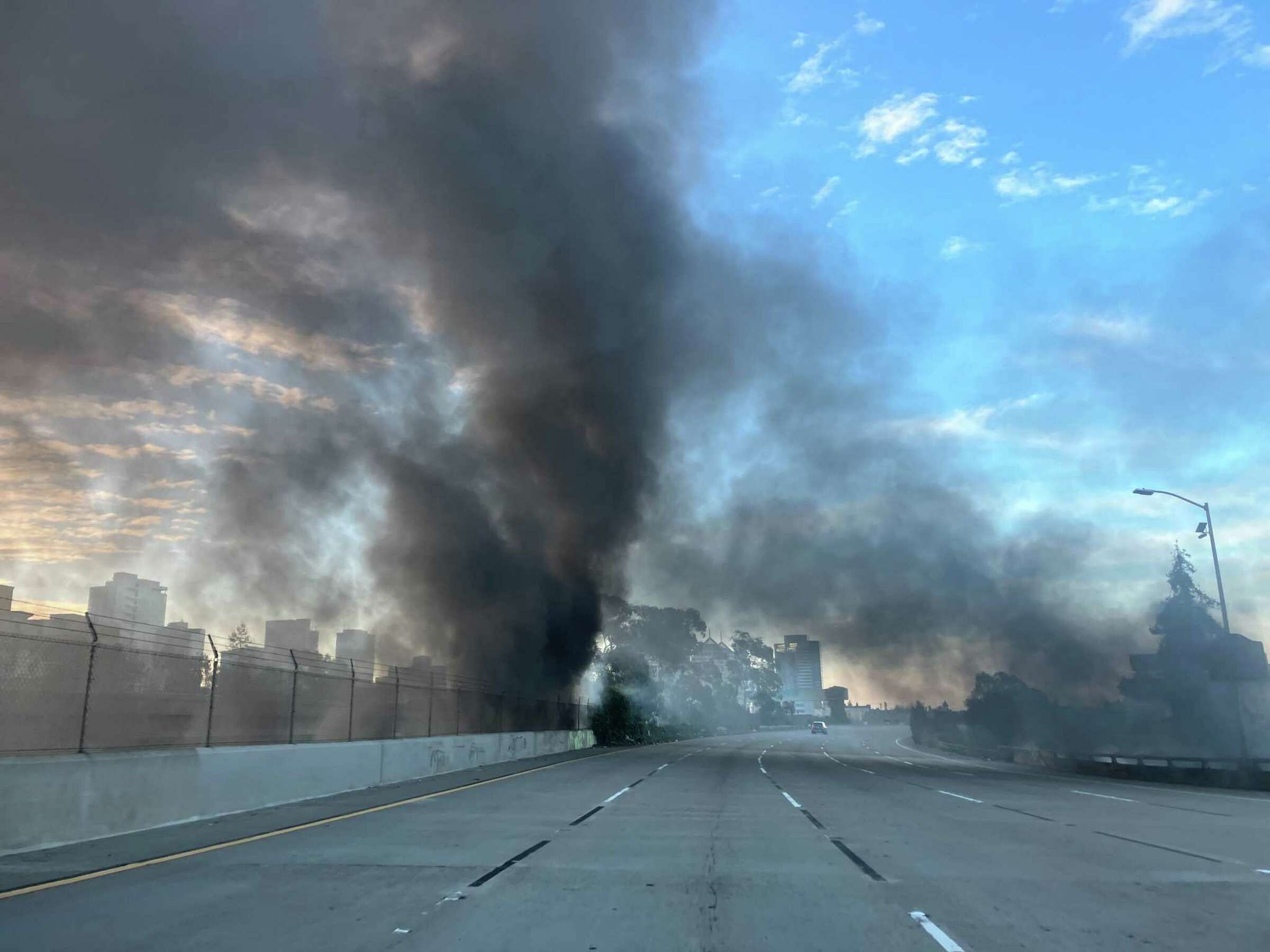 Encampment fire under I-980 sends smoke rising near downtown Oakland