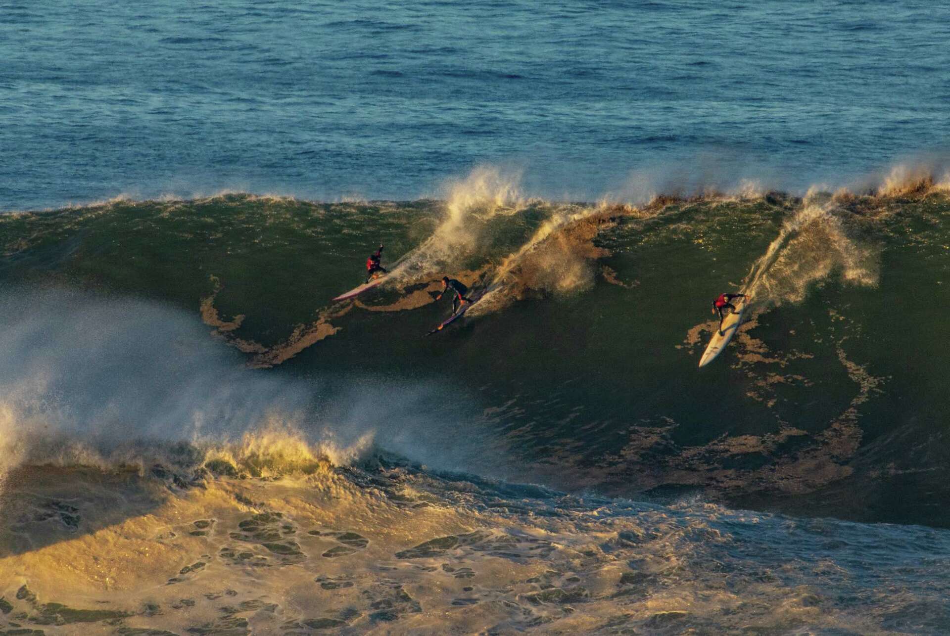 Elite surfers ride historic waves at Mavericks on California coast