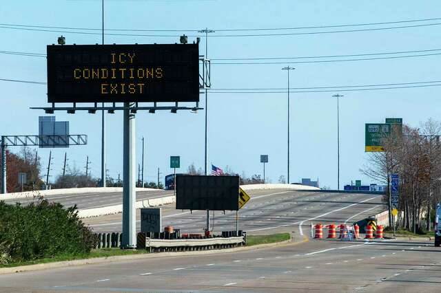 Which Houston roads are covered by ice from freezing weather?